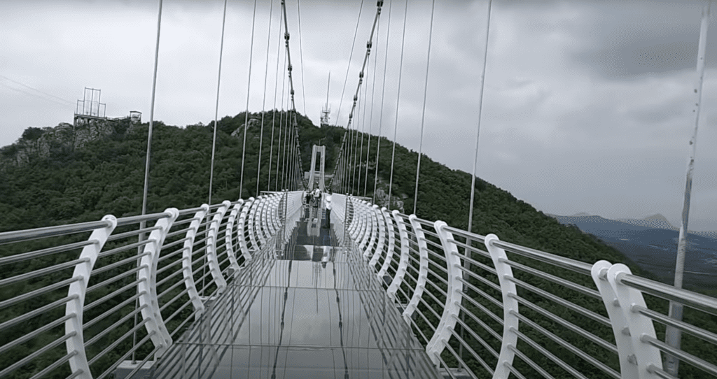 Glass Bridge Shatters, Man Hangs on For Dear Life